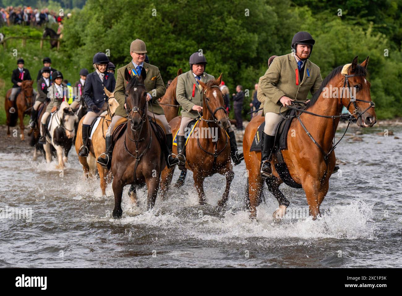 Riders ford the River Ettrick during the Selkirk Common Riding, a ...