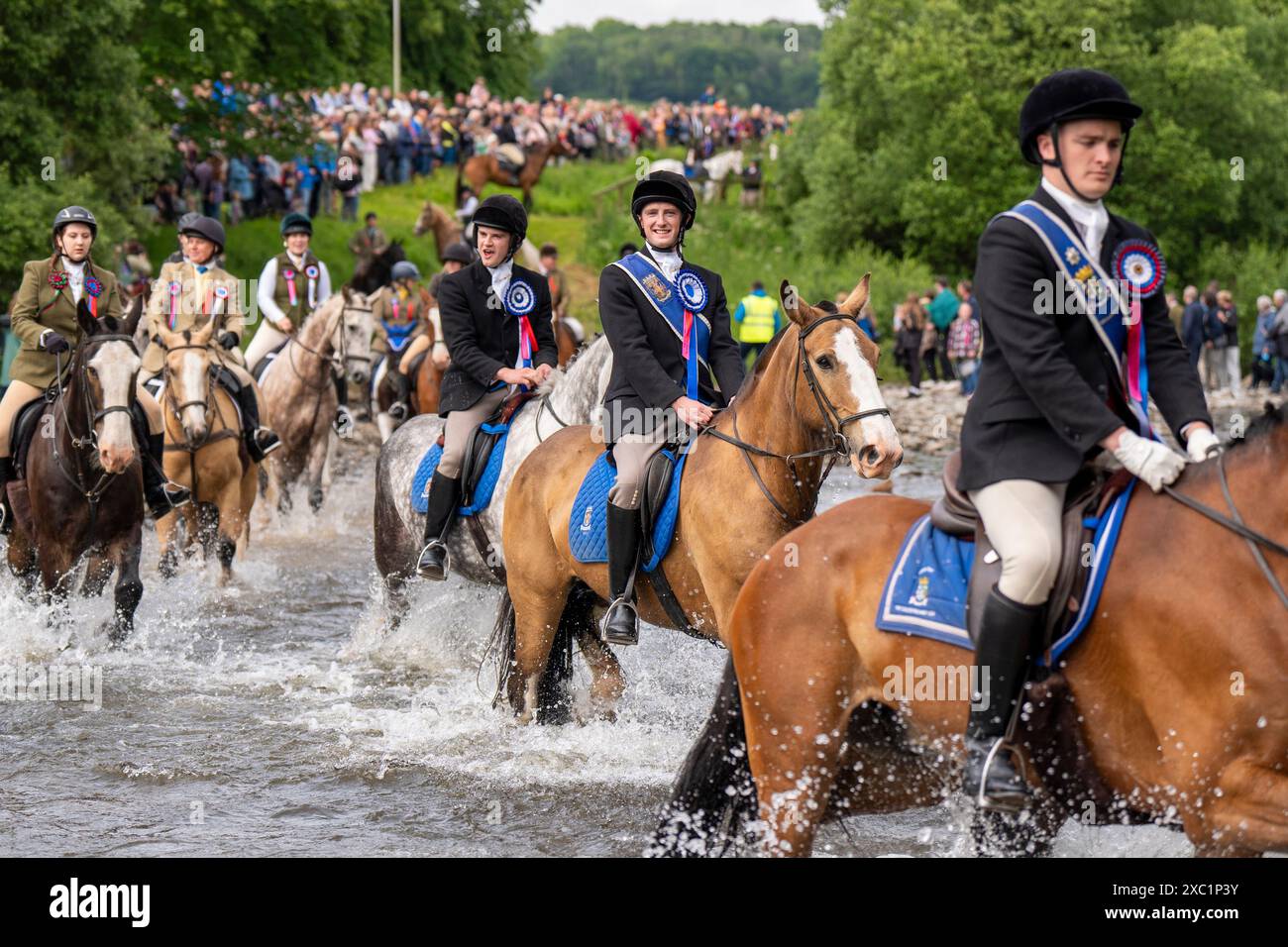 Riders ford the River Ettrick during the Selkirk Common Riding, a ...