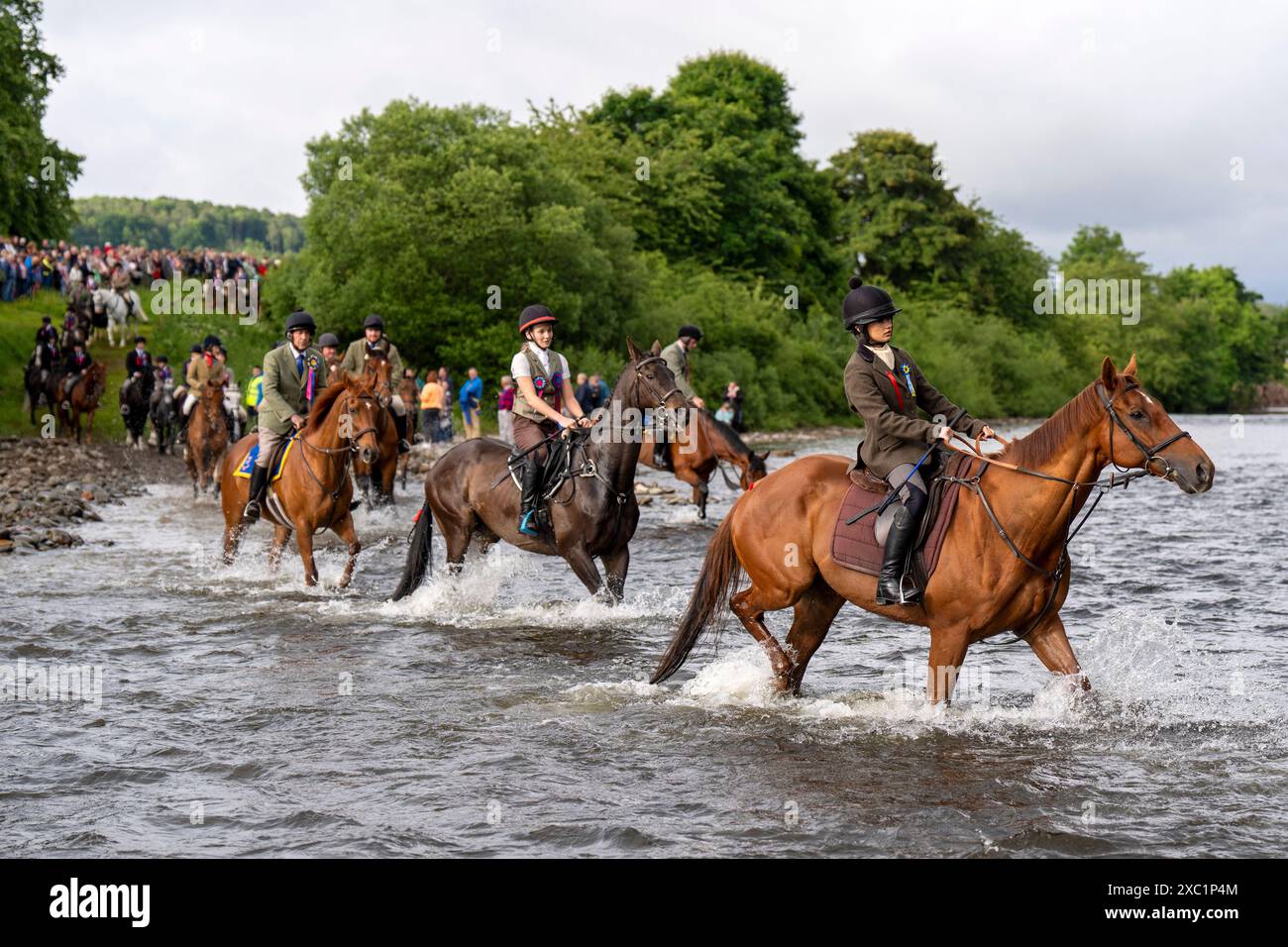 Riders ford the River Ettrick during the Selkirk Common Riding, a ...