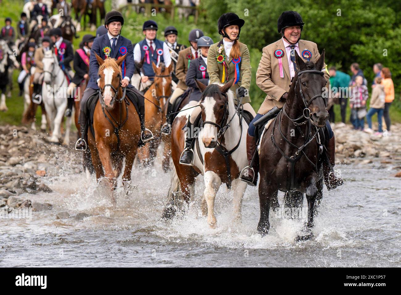 Riders ford the River Ettrick during the Selkirk Common Riding, a ...