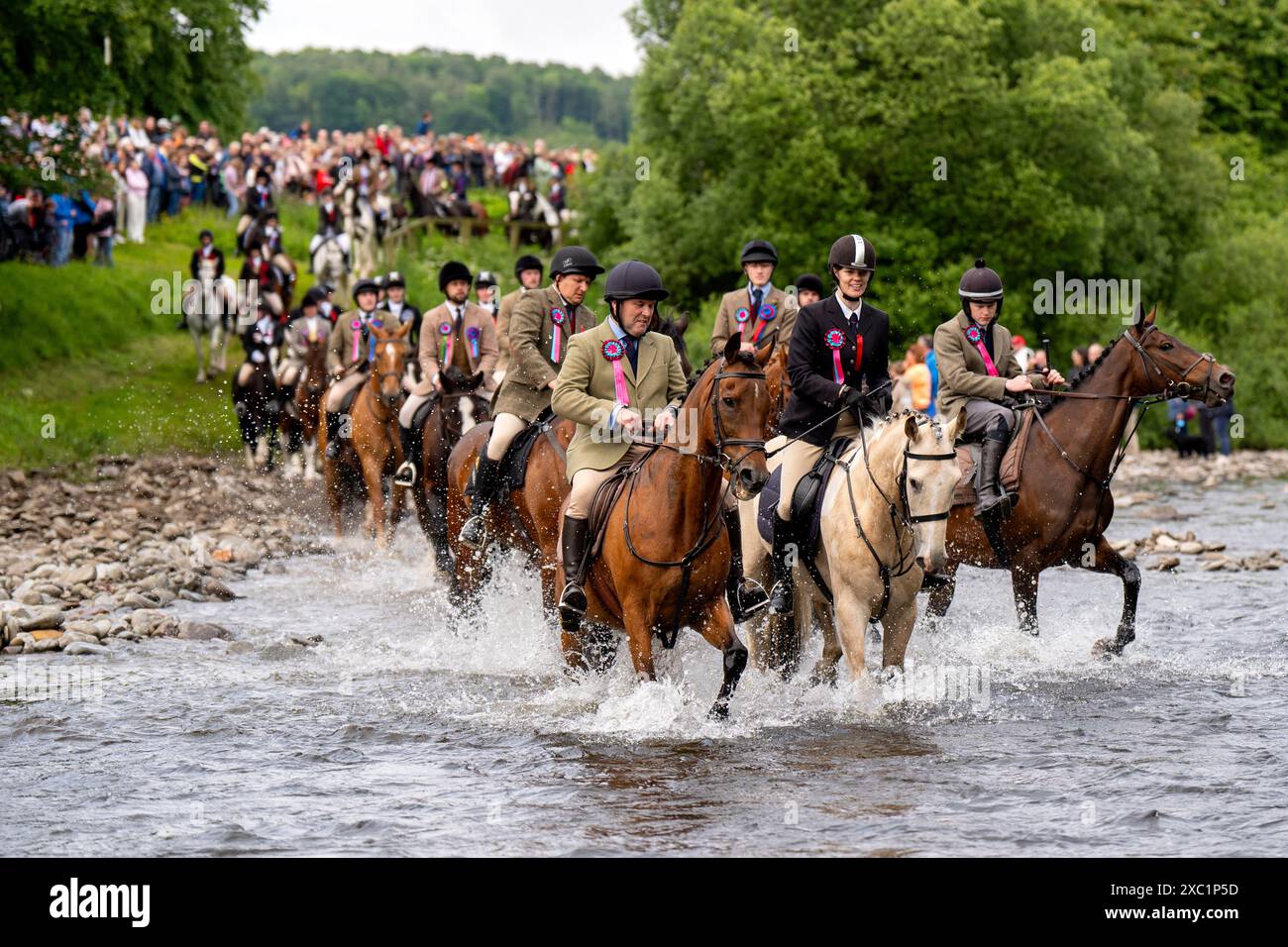 Riders ford the River Ettrick during the Selkirk Common Riding, a ...