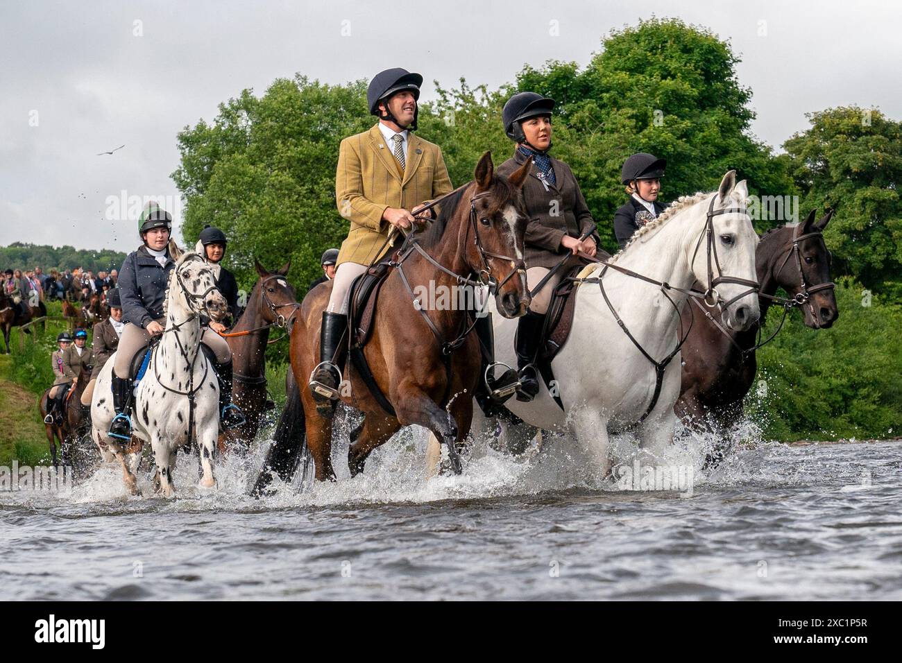 Riders ford the River Ettrick during the Selkirk Common Riding, a ...