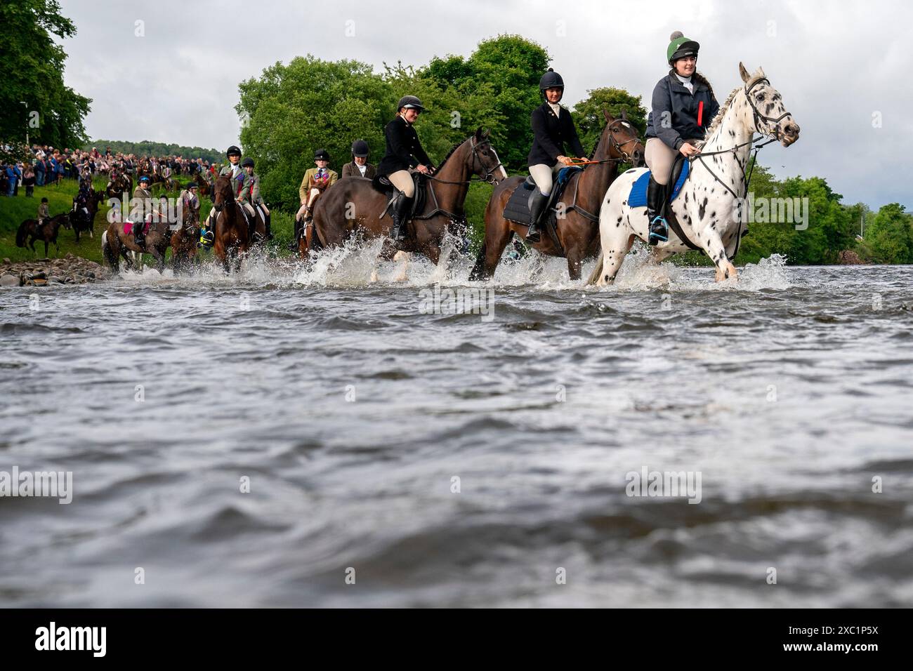 Riders ford the River Ettrick during the Selkirk Common Riding, a ...