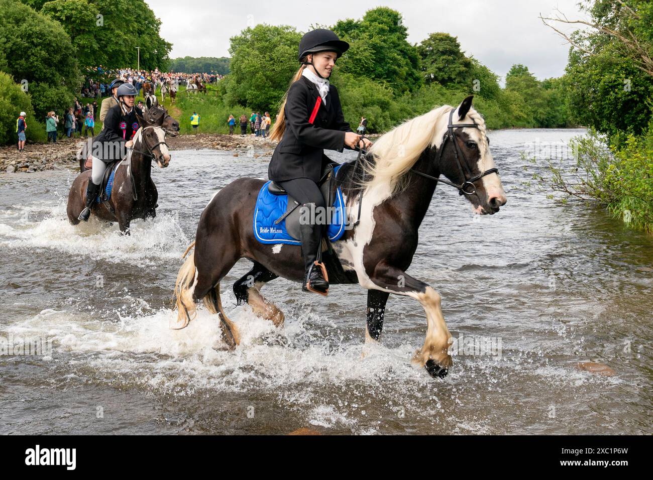 Riders ford the River Ettrick during the Selkirk Common Riding, a ...