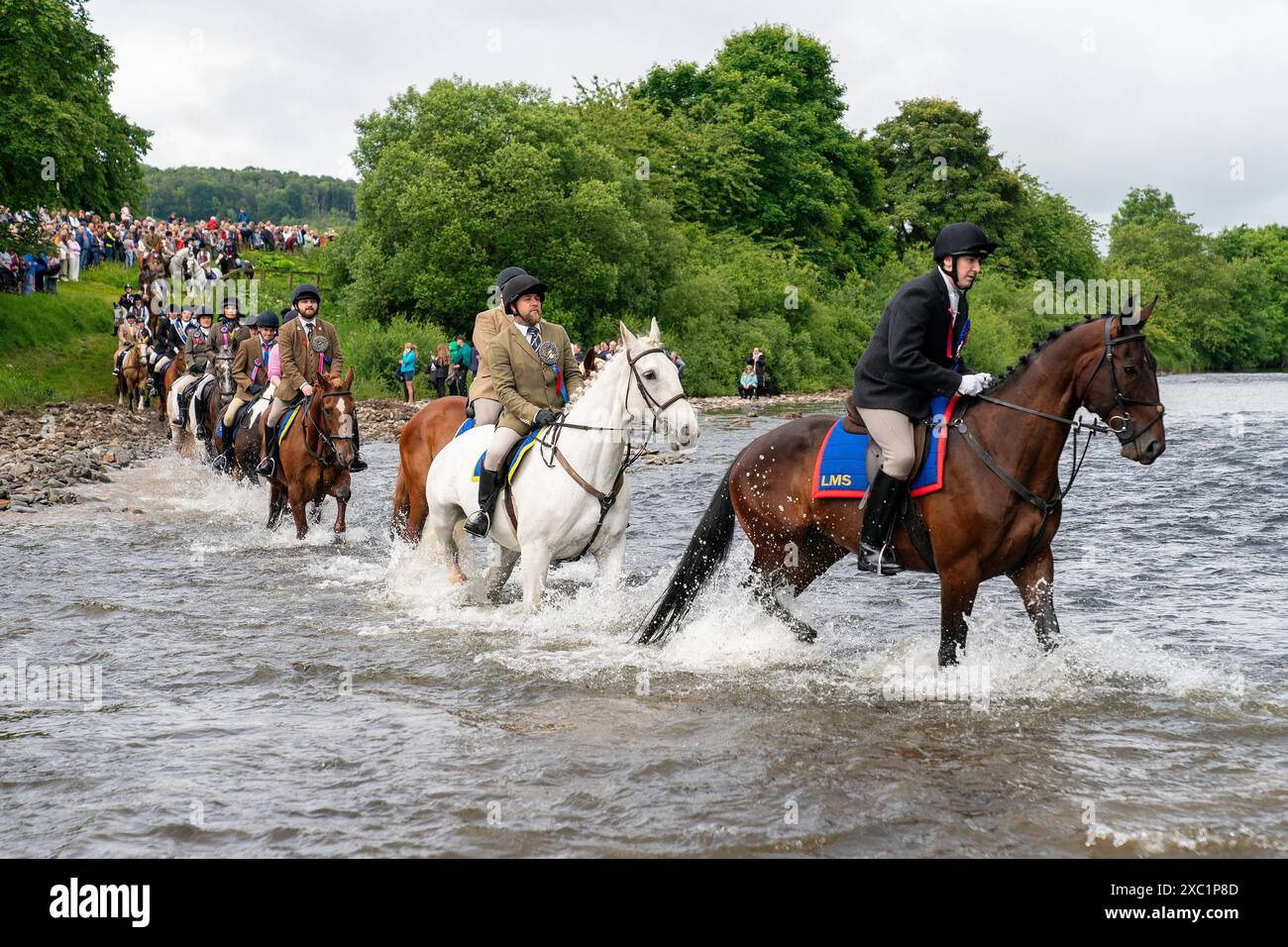 Riders ford the River Ettrick during the Selkirk Common Riding, a ...