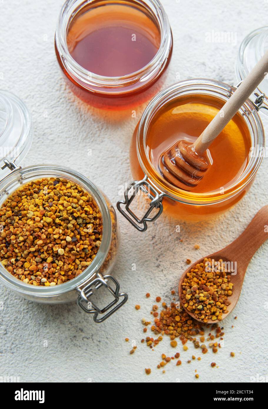 Raw organic bee pollen and honey in jars Stock Photo - Alamy