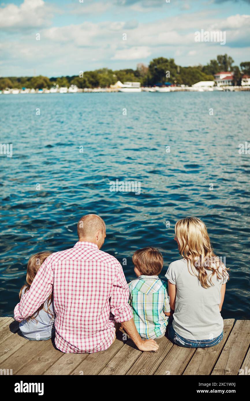 Family, lake and jetty on vacation for bonding, peace and travel to ...