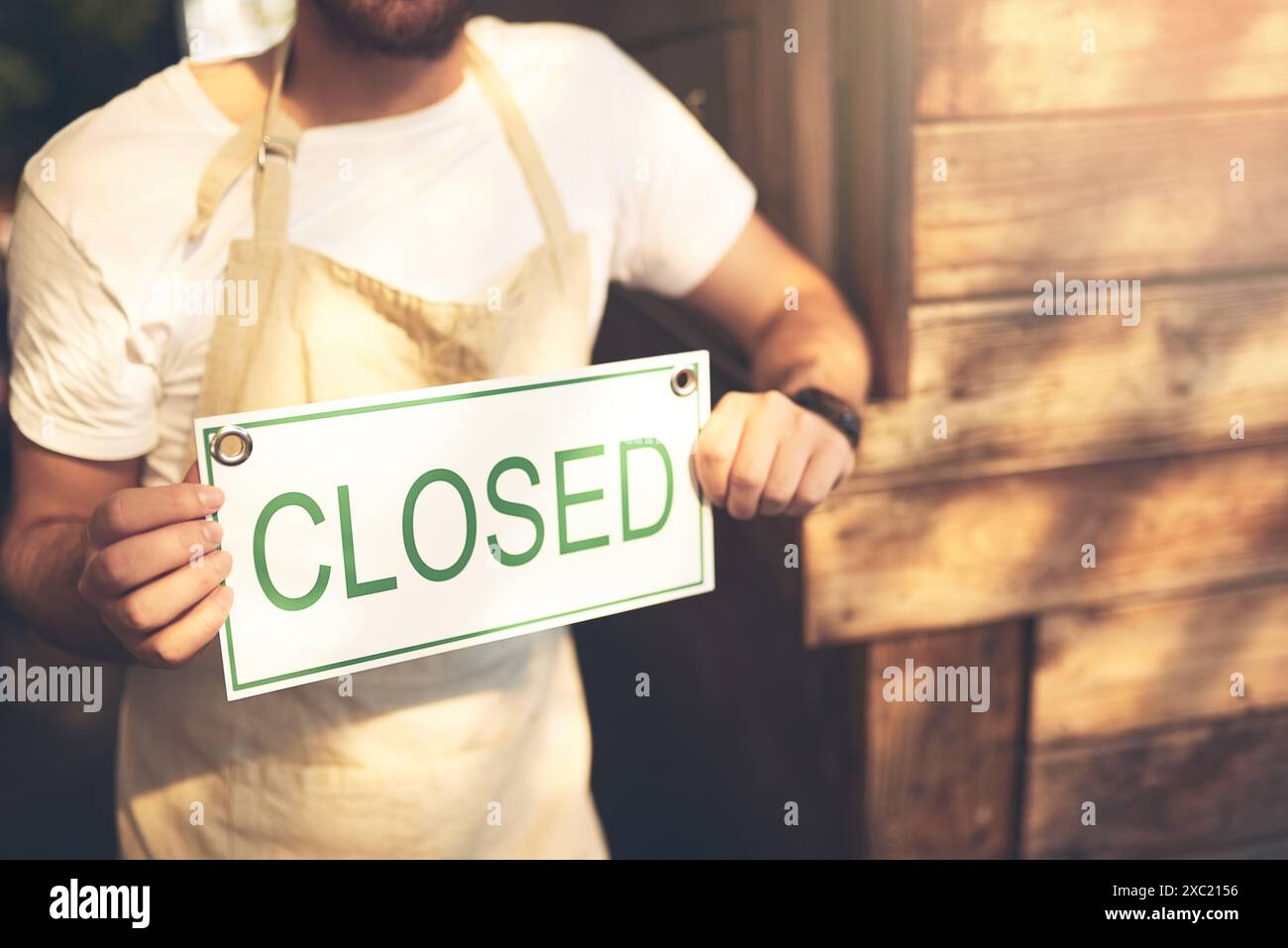 Small business, closed sign and hands of person by cafe, restaurant or ...