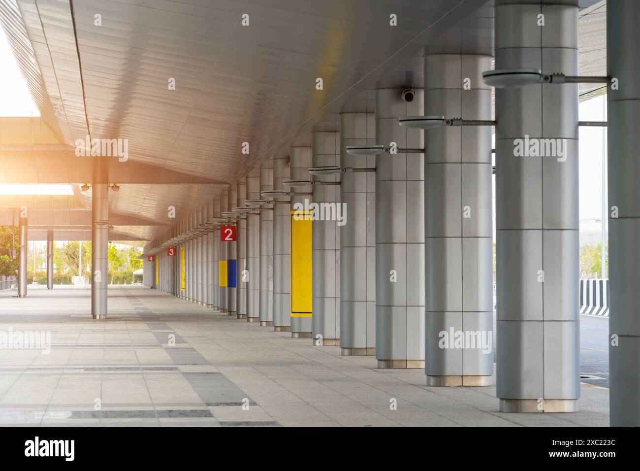 Rows of long white pillars support and strengthen the roof of a large ...