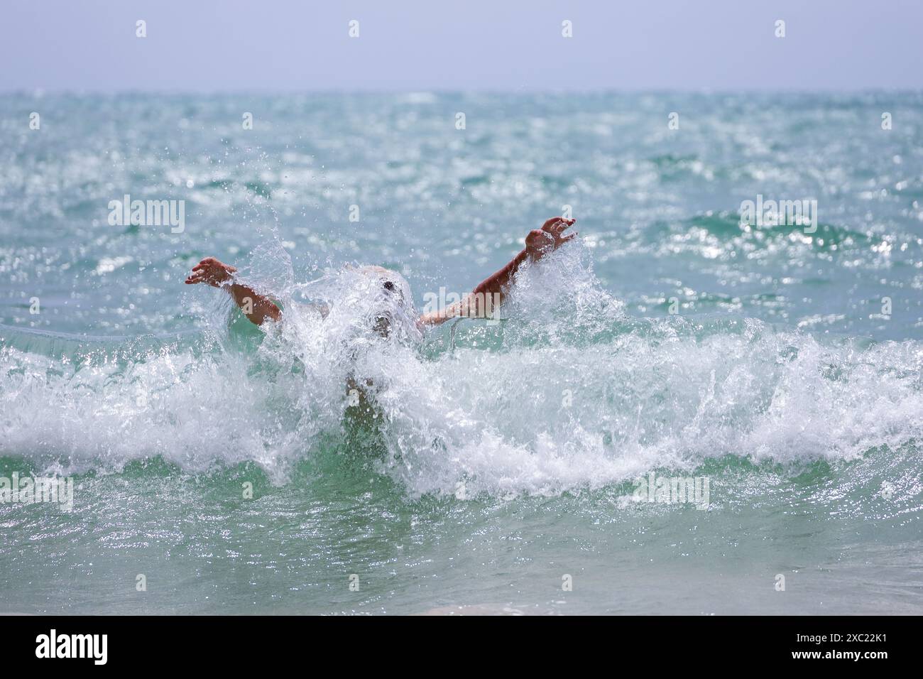 Beach vacation, man swimming in the sea, splashing in transparent water ...