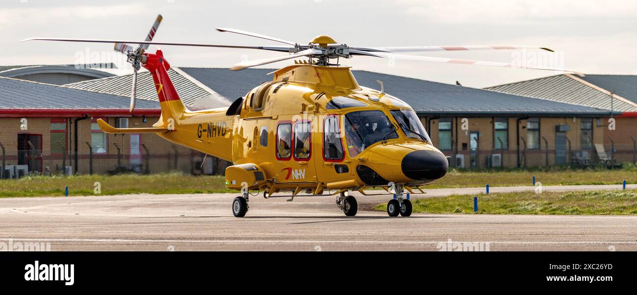 Yellow NHV helicopter with black nose taxiing at Blackpool Airport ...