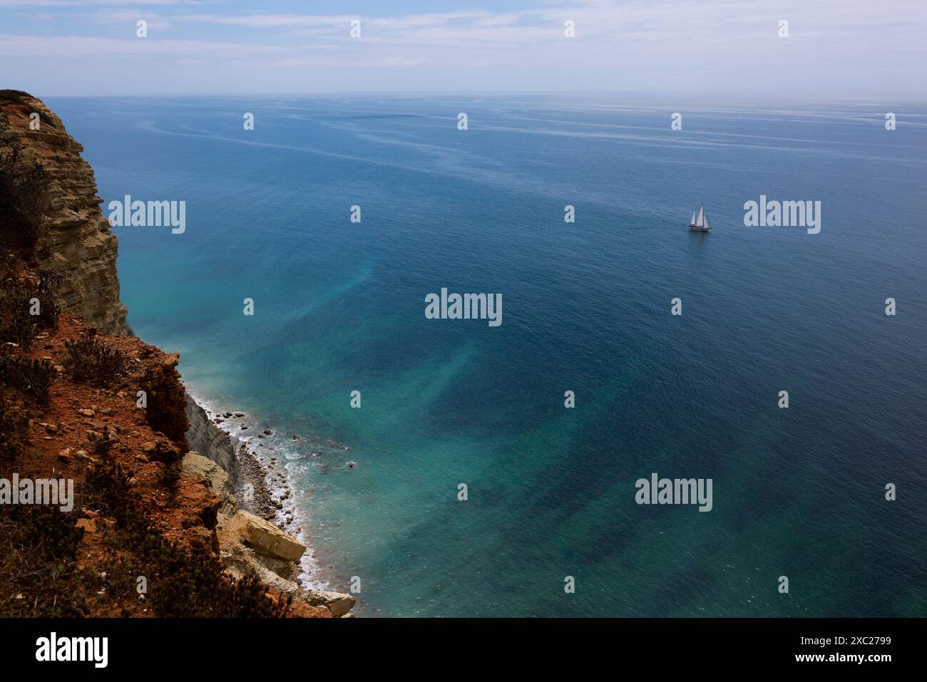 Sailboat on the Atlantic Ocean seen from Algarve cliffs, Portugal Stock ...
