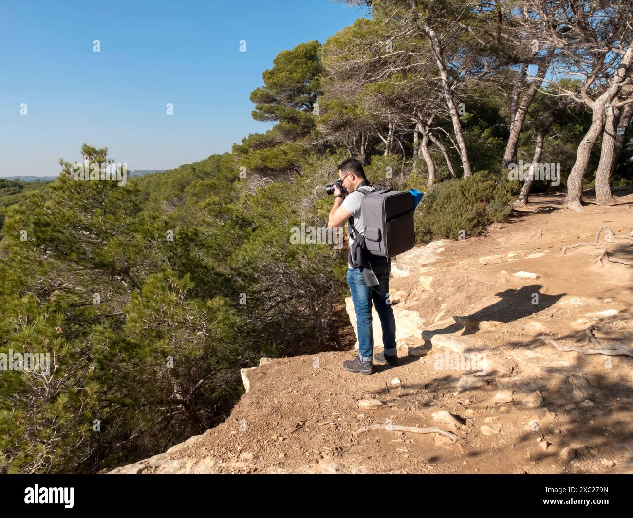 Professional photographer taking photos of beautiful nature scenery ...