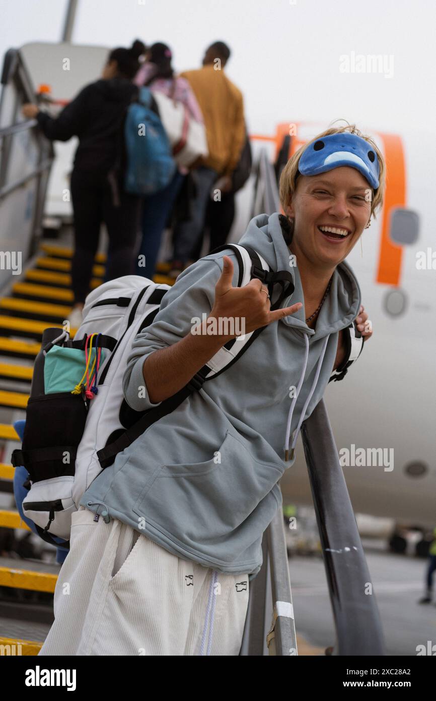 Woman passenger boarding on airplane at airport Stock Photo - Alamy