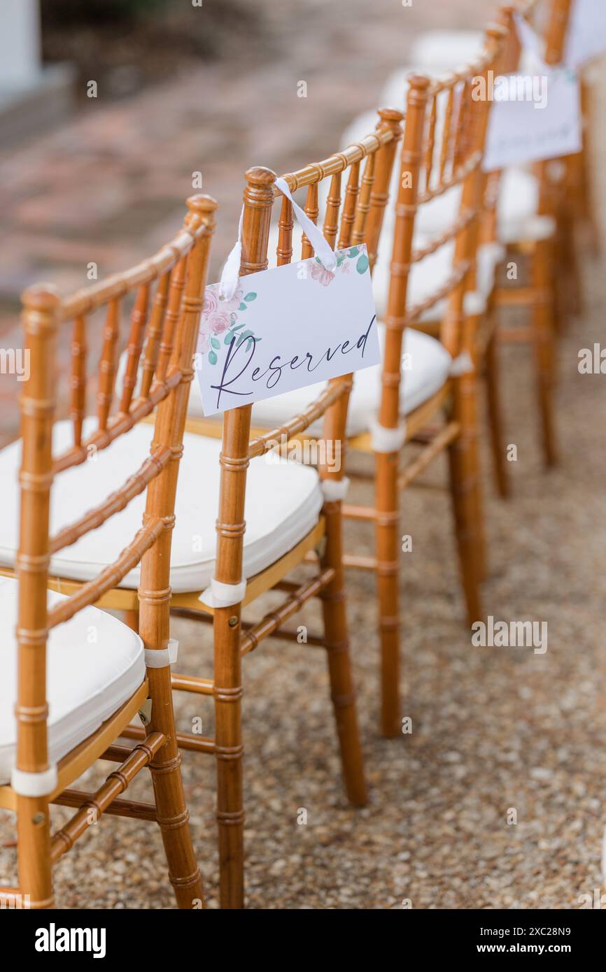 Wooden chairs with reserved sign Stock Photo - Alamy