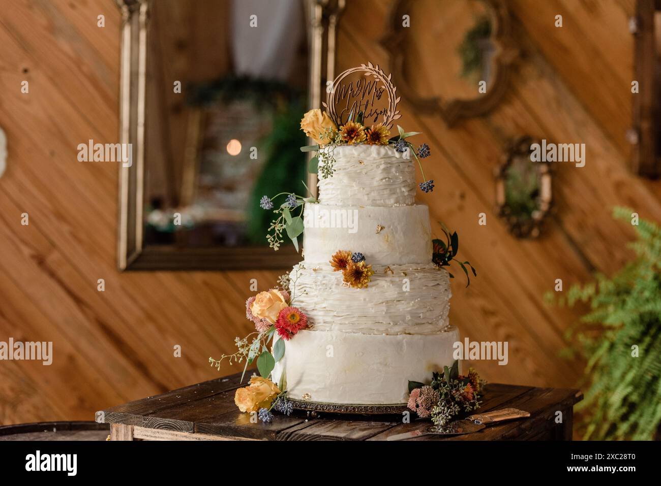 Rustic wedding cake with textured icing and fall flowers Stock Photo ...