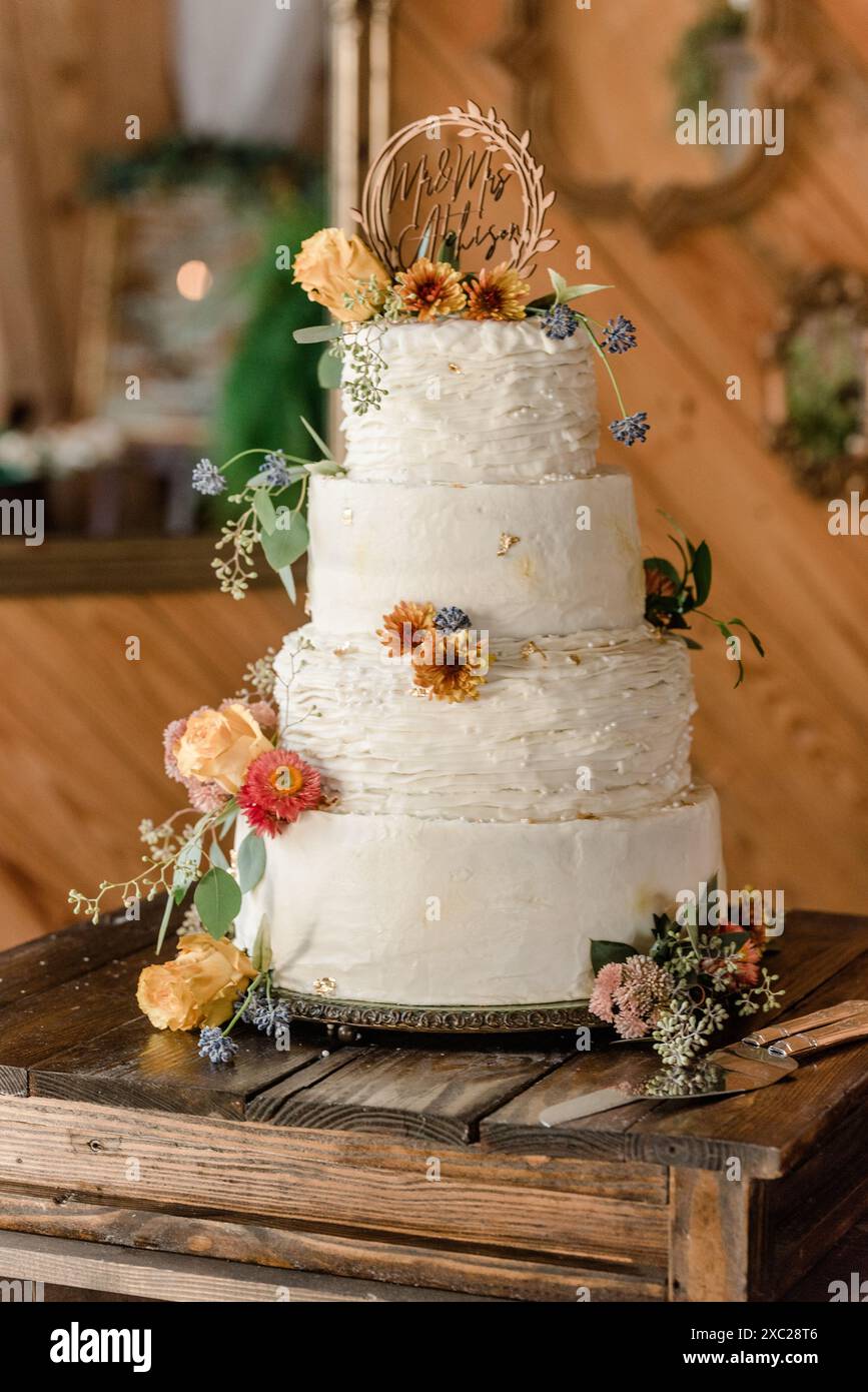 Rustic wedding cake with textured icing and fall flowers Stock Photo ...