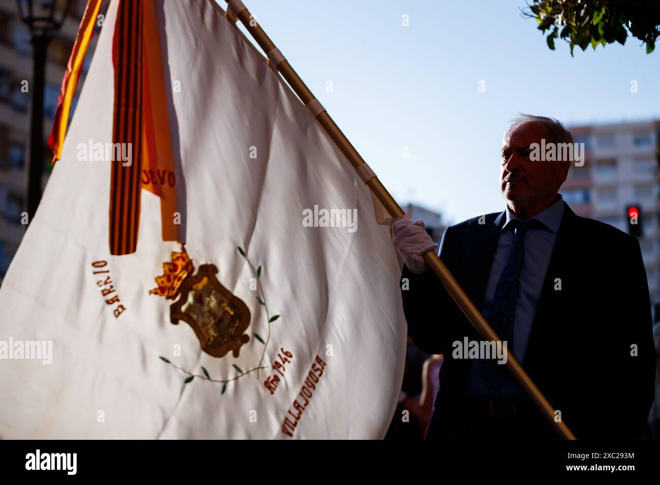 man carrying flag in the Corpus Christi procession Stock Photo - Alamy