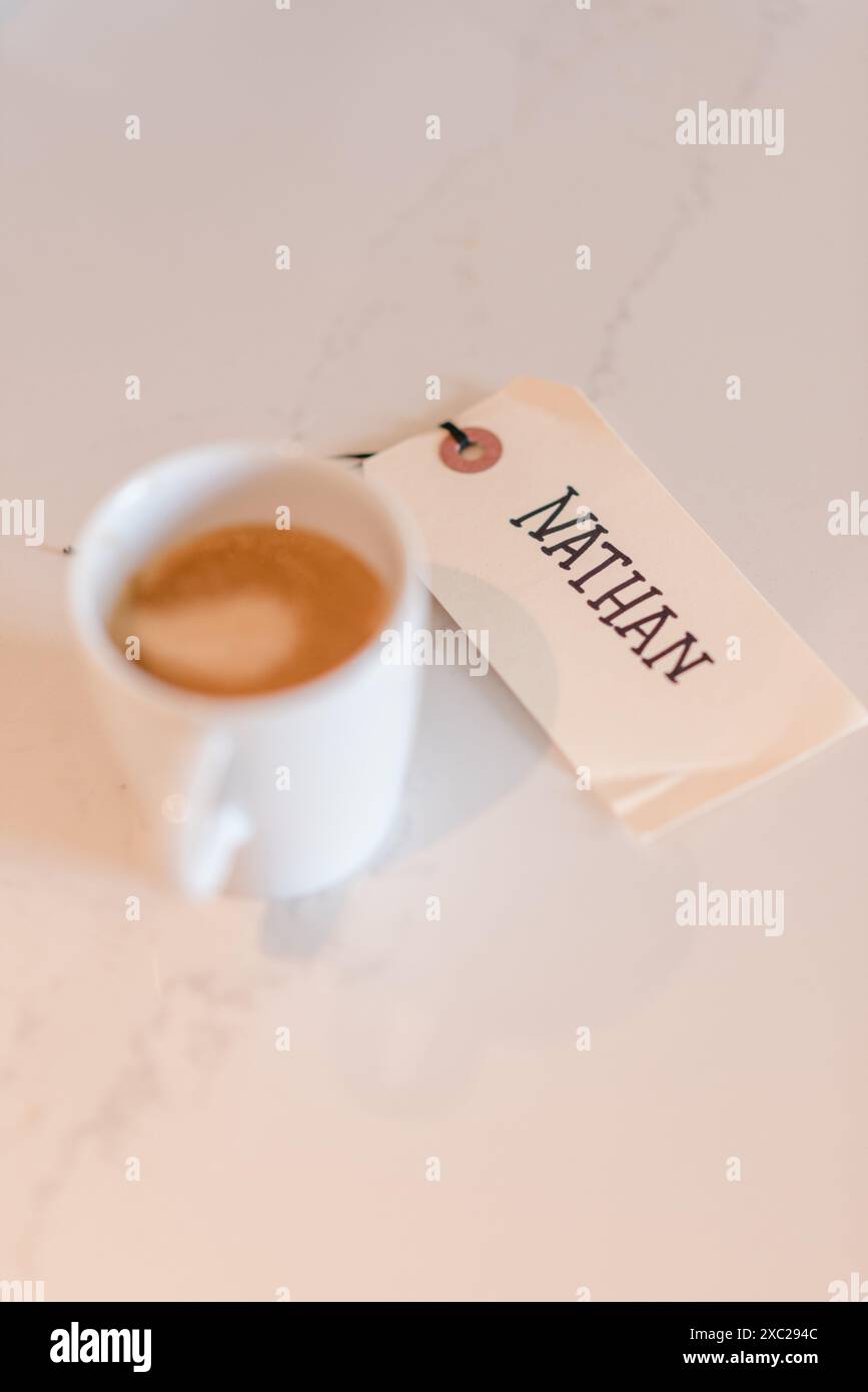 White Coffee cup with cream name tag Stock Photo - Alamy