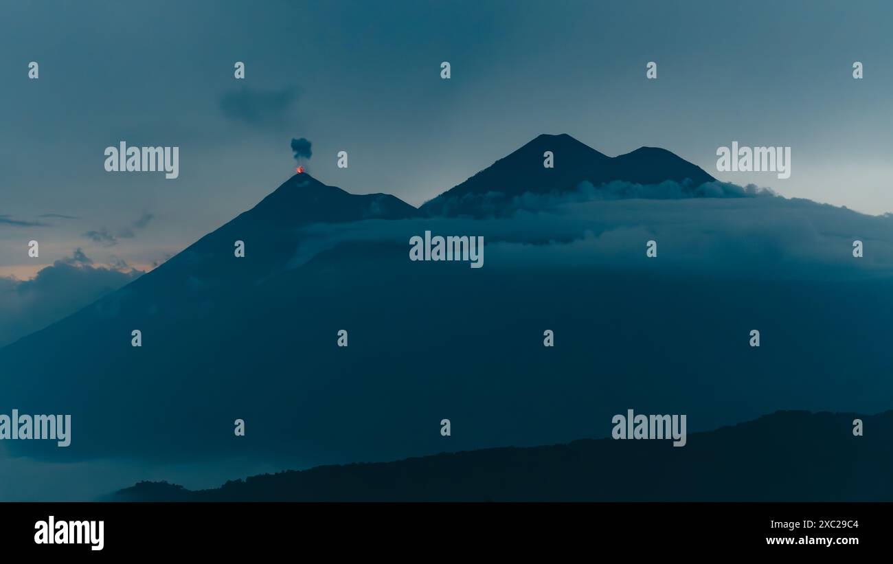 Fuego volcano from Antigua Guatemala during sunrise Stock Photo - Alamy