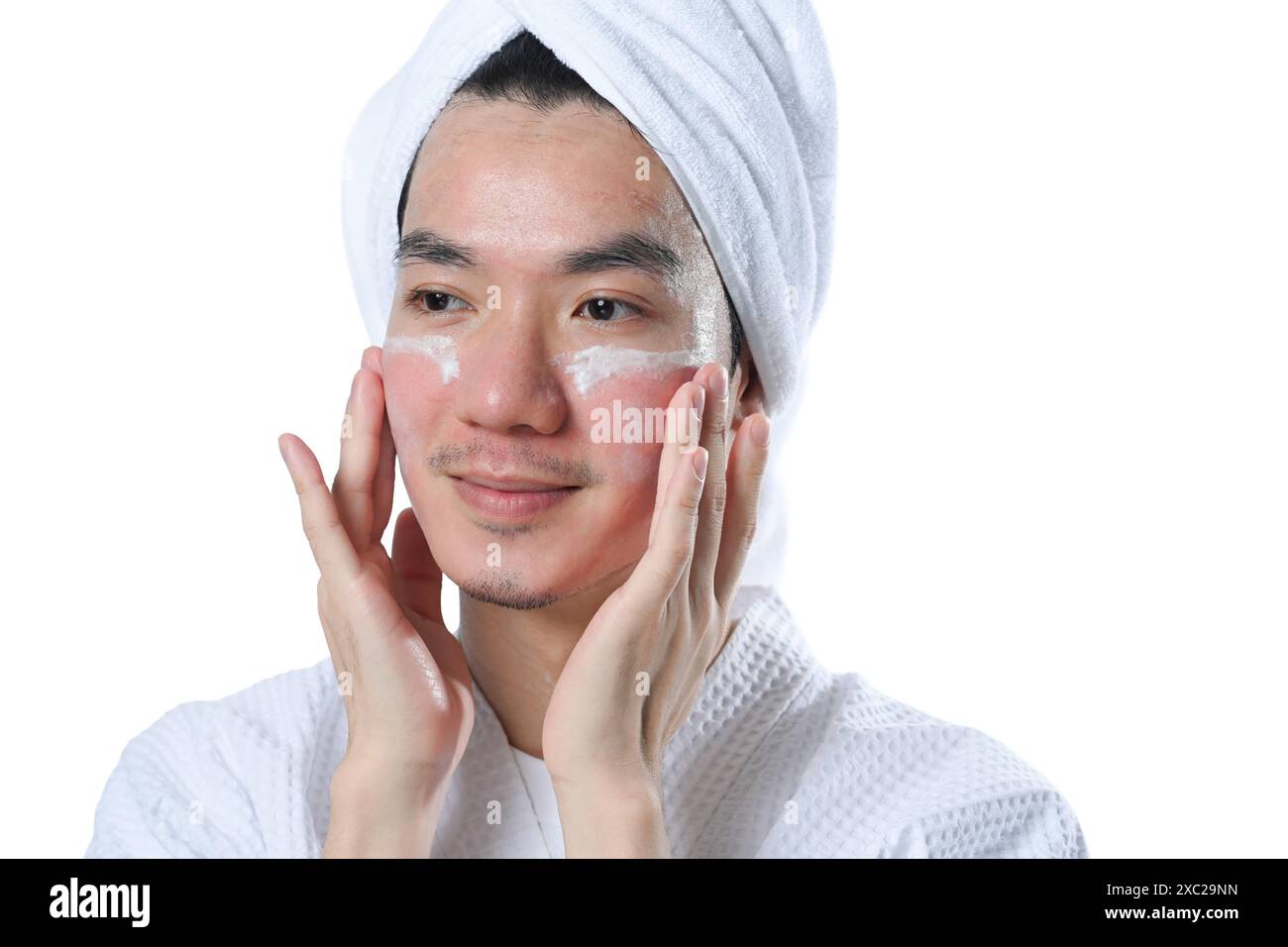 Man applying moisturizing and anti aging cream on his face after shower. Skin care and cosmetic ...