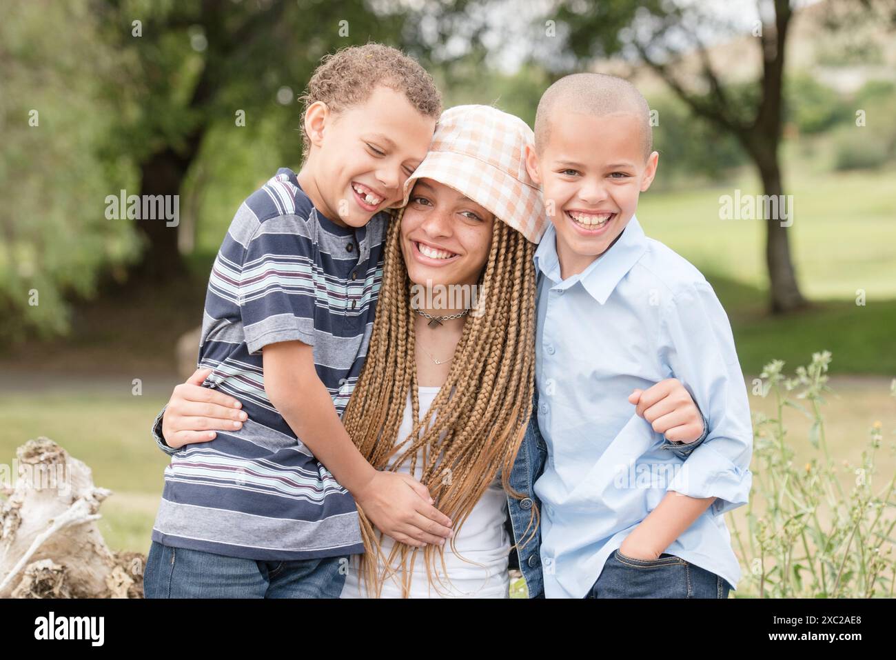 Siblings hugging and laughing together Stock Photo - Alamy