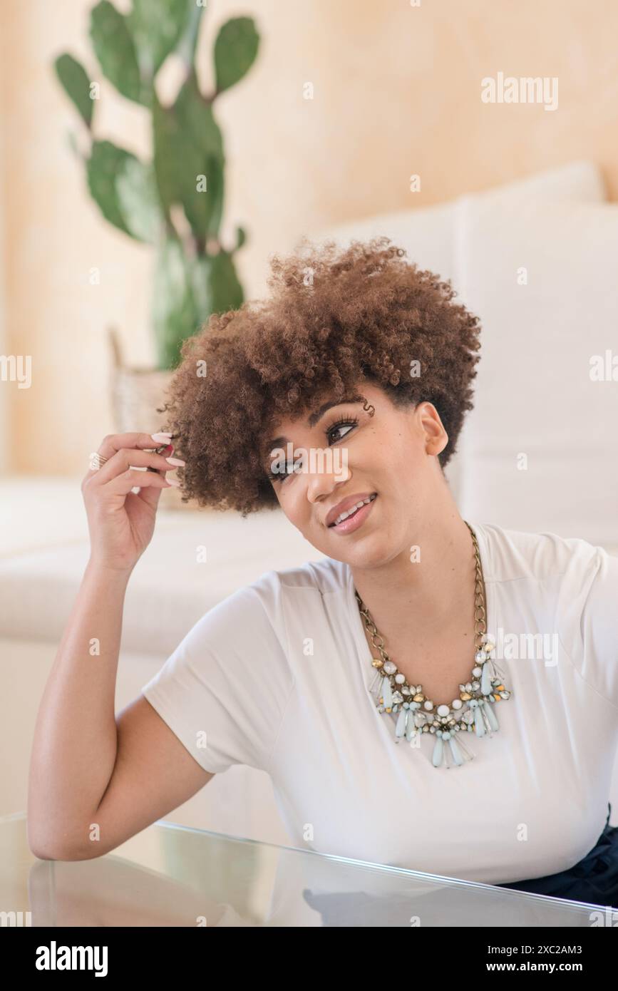 Woman afro hair looking down hi-res stock photography and images - Alamy