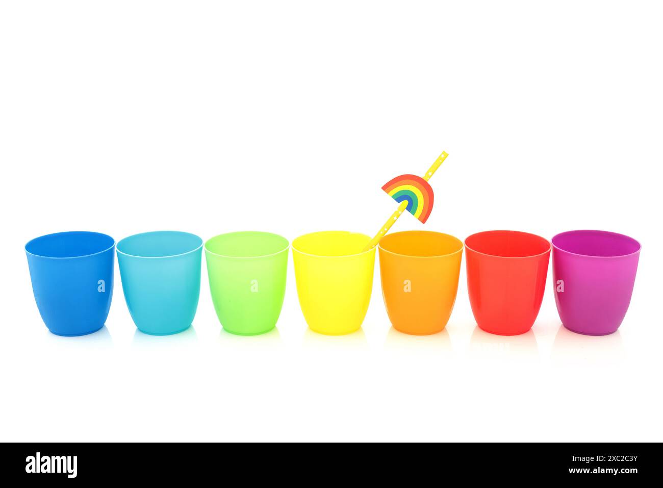 Rainbow drinking cups in a line on white background. Minimal colorful ...