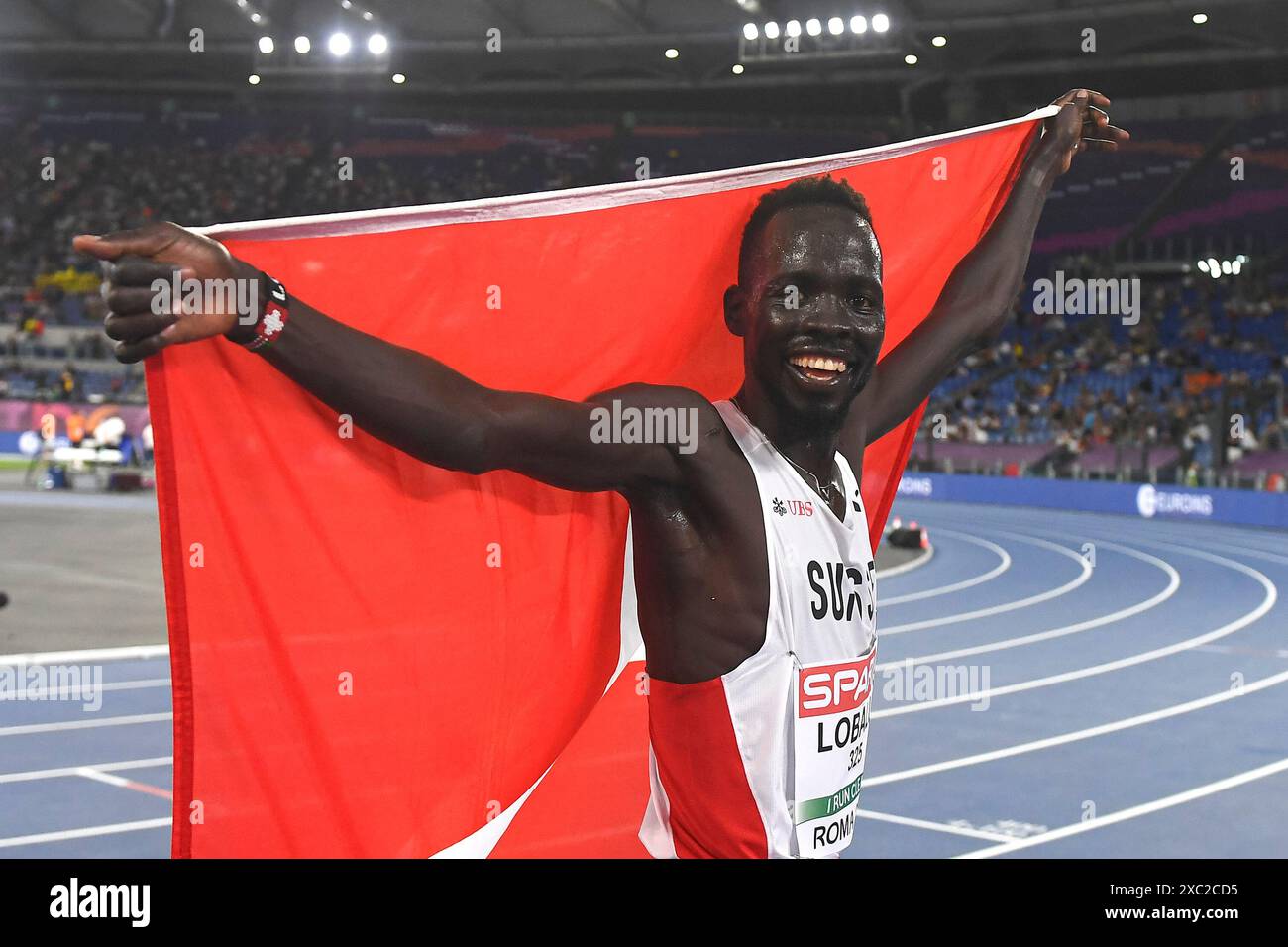 Dominic Lokinyomo Lobalu of Switzerland celebrates after competing in ...