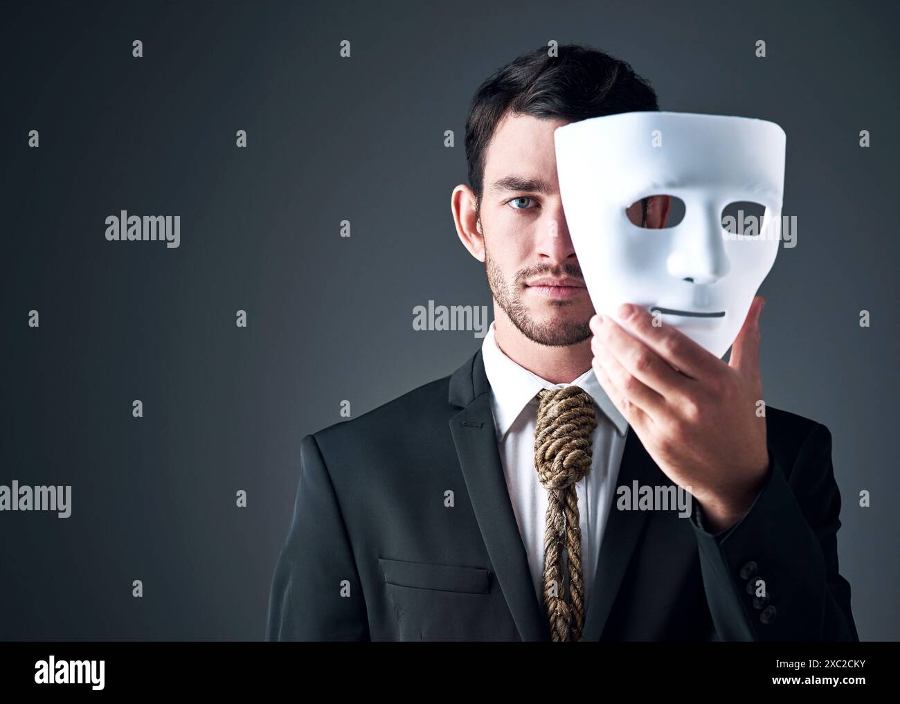 Portrait, business man and spy with mask in studio isolated on gray ...