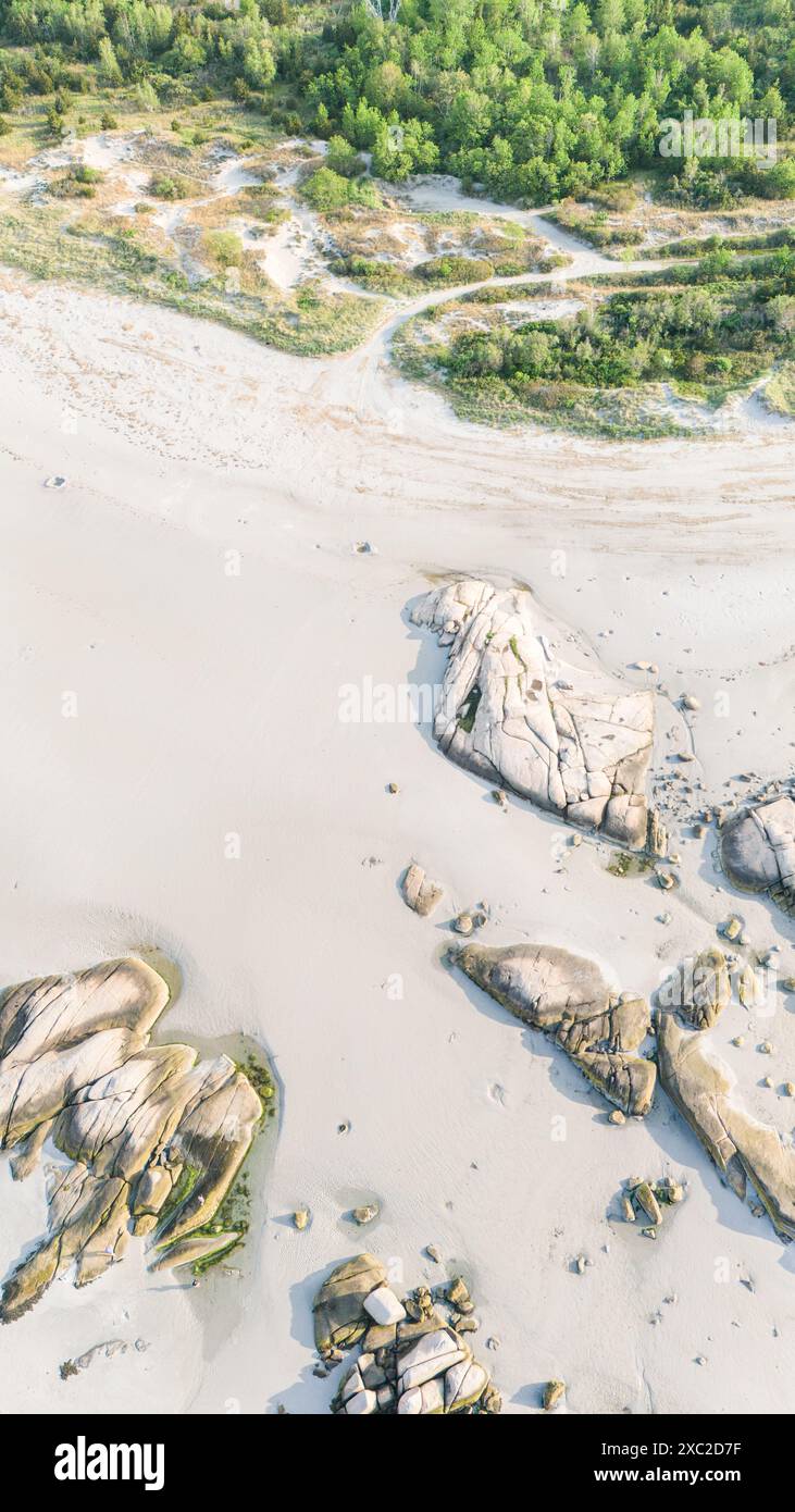 Aerial view of sandy beach, rocks, and greenery at Wingaersheek Beach ...