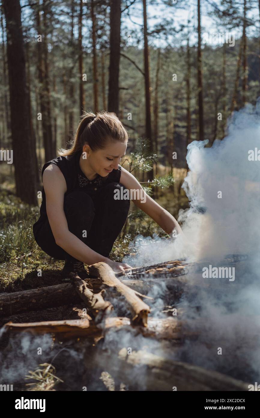 Woman is cooking on a bonfire. cooking on an open fire, camping Stock ...