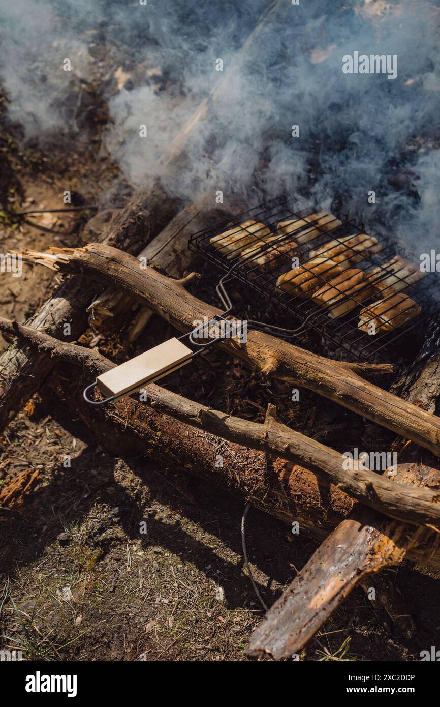 Food cooked on a bonfire on the grill over an open fire Stock Photo - Alamy