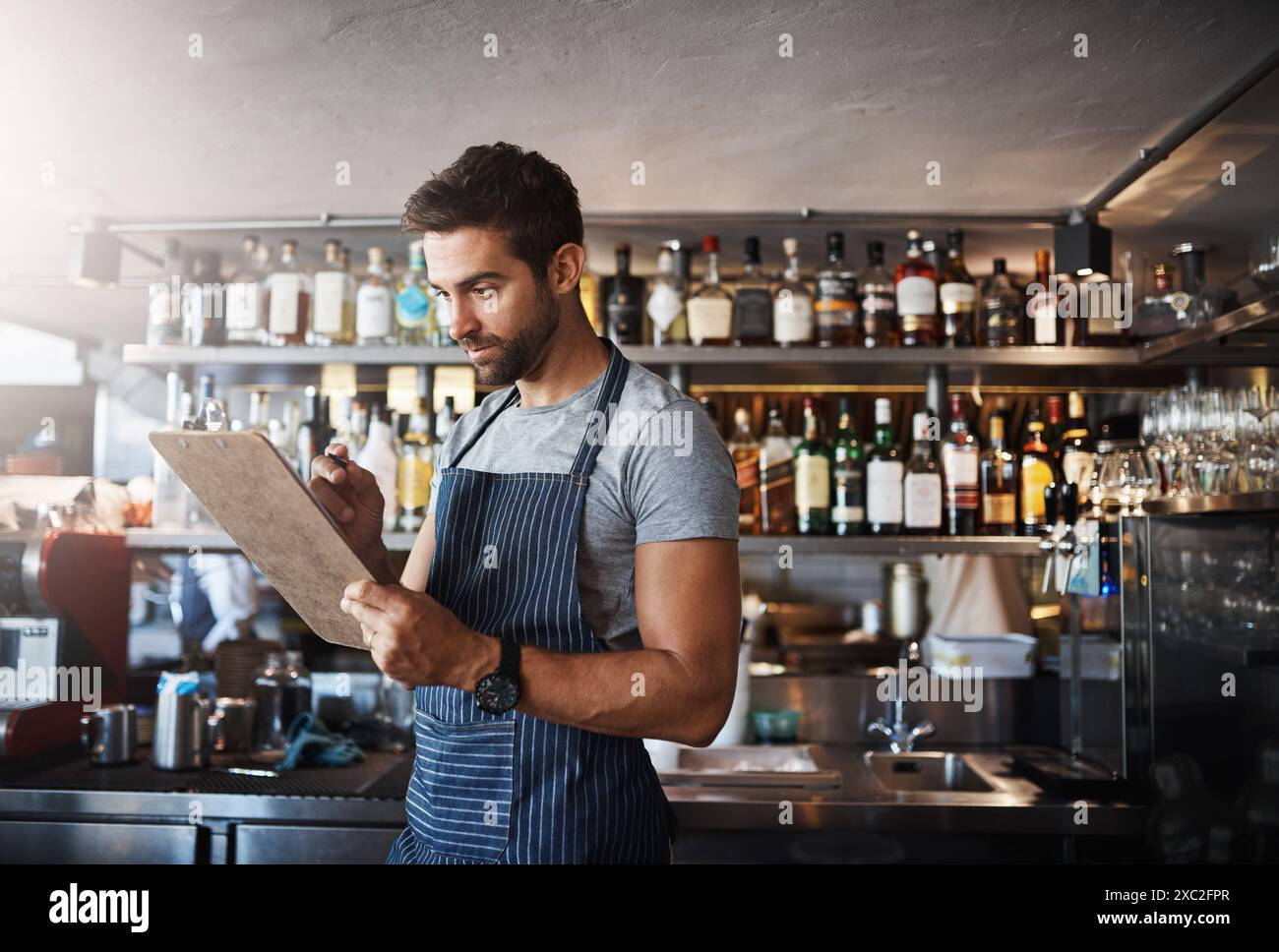 Bartender, writing and clipboard for restaurant management with stock ...