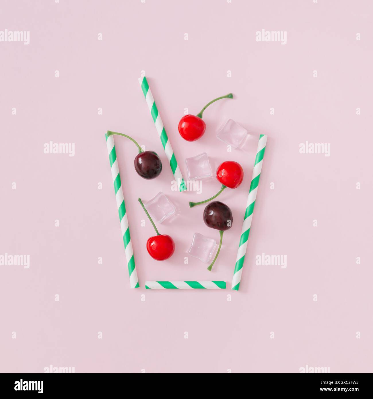 Creative layout made of red cherries, ice cubes and drinking straw on light pink background ...