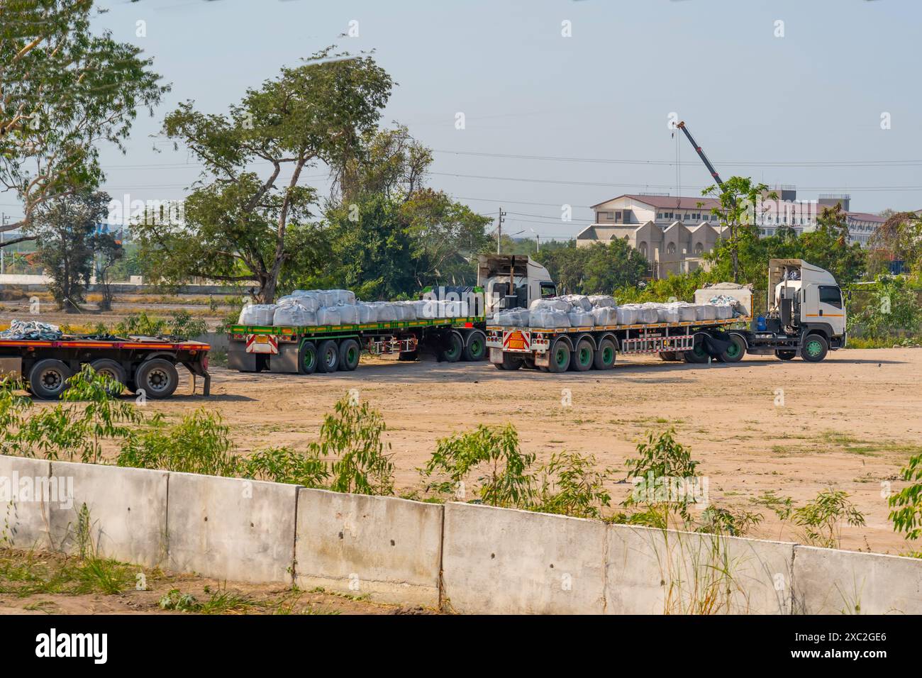 Trucks with long trailers loaded with bulk cargo sacks parked awaiting ...