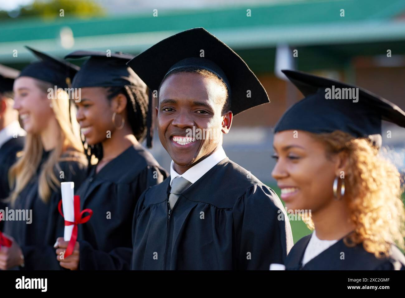 Happy black man, scholar portrait and graduation class with group at ...