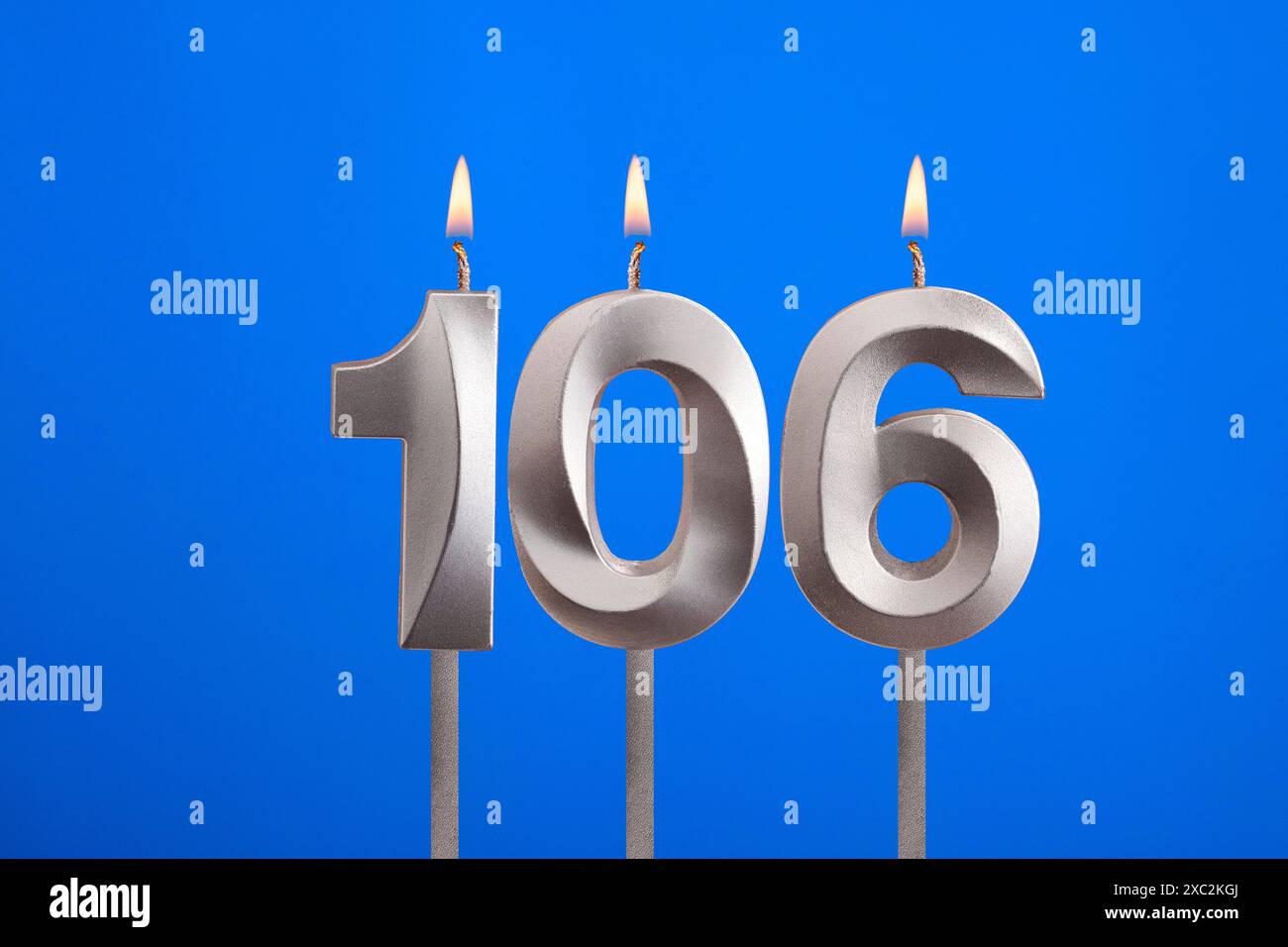 Birthday number 106 - Candle lit on blue background Stock Photo - Alamy