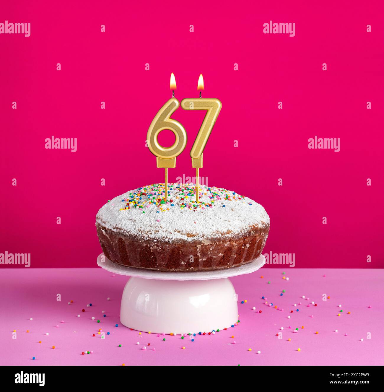 Birthday cake with number 67 candle on pink background Stock Photo - Alamy