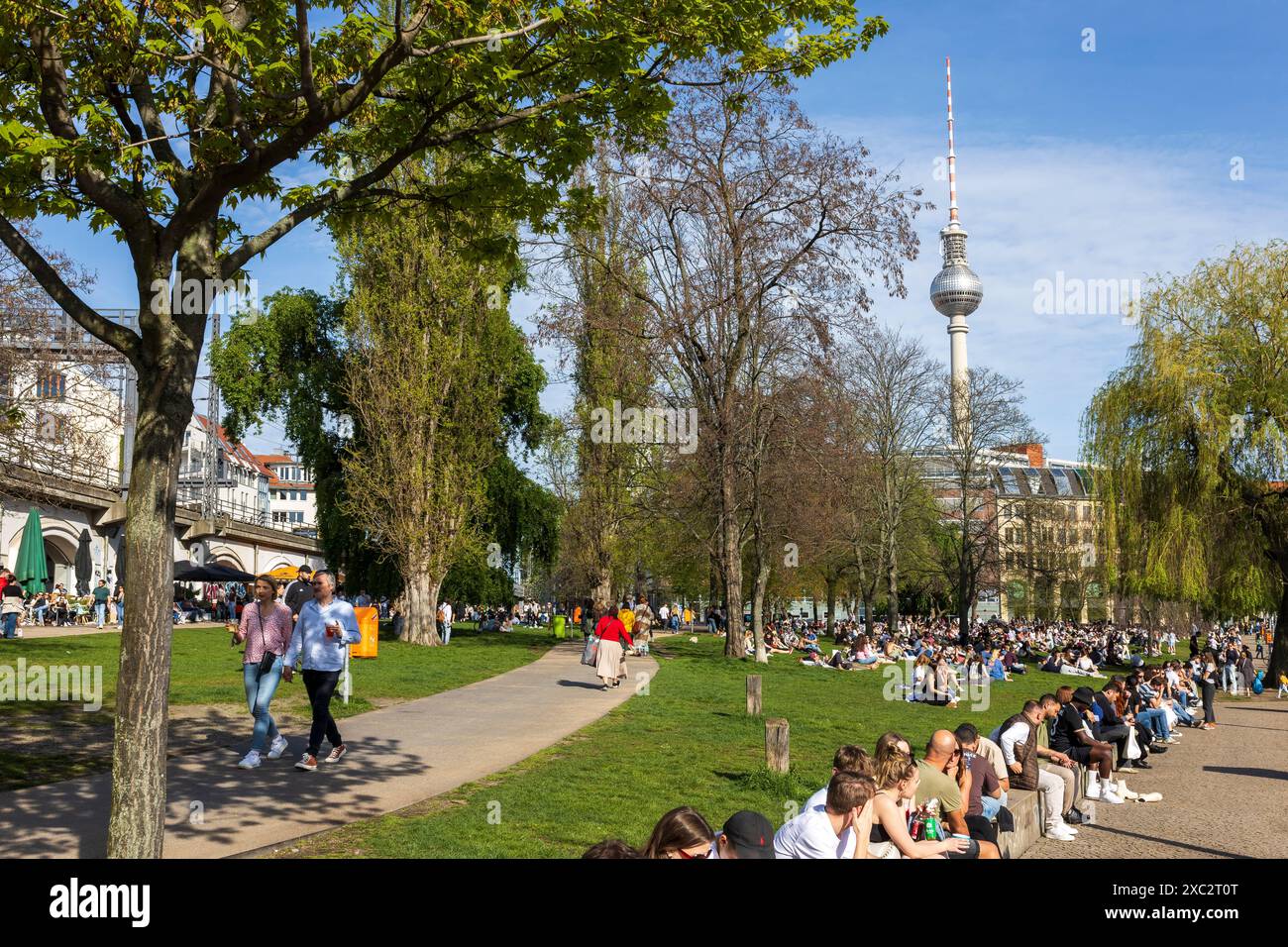 Berlin, Germany - 02 April 2024, People are sitting on the embankment ...
