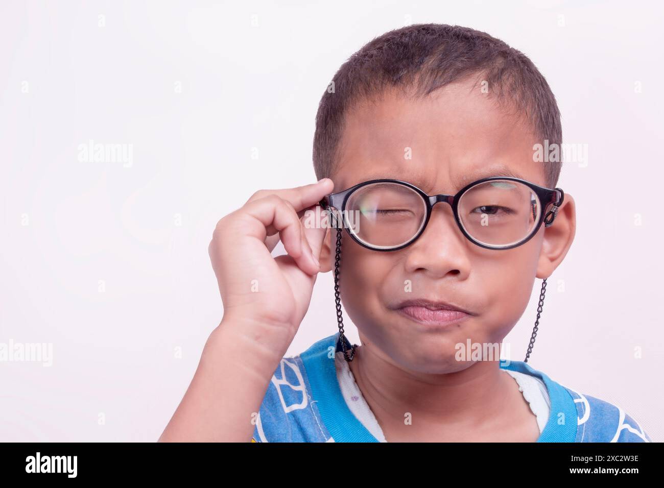 closeup, asian teenager holding nearsighted glasses. vision examination ...