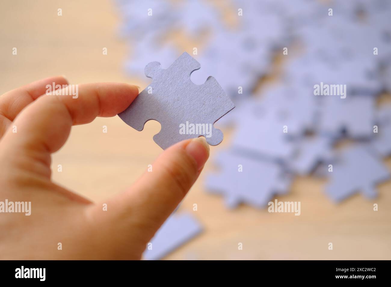 cardboard puzzle piece in female hand, puzzle assembly on psychological ...