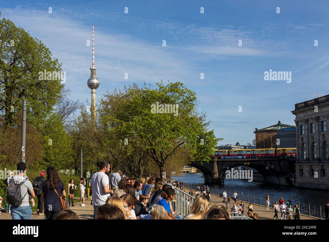 Berlin, Germany - 02 April 2024, People are sitting on the embankment ...