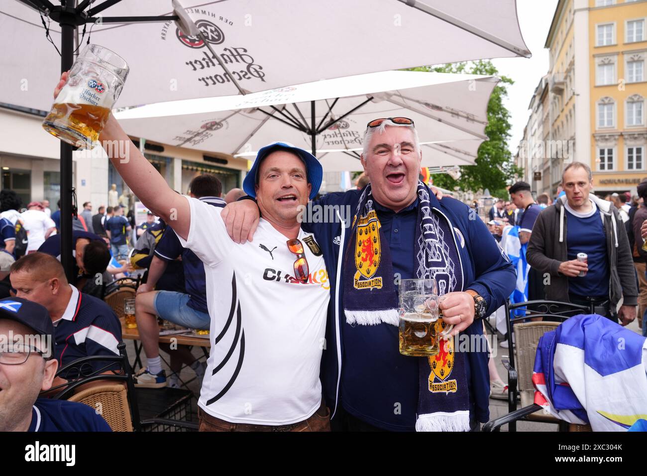 Germany and Scotland fans pose for a photo at Marienplatz square ...