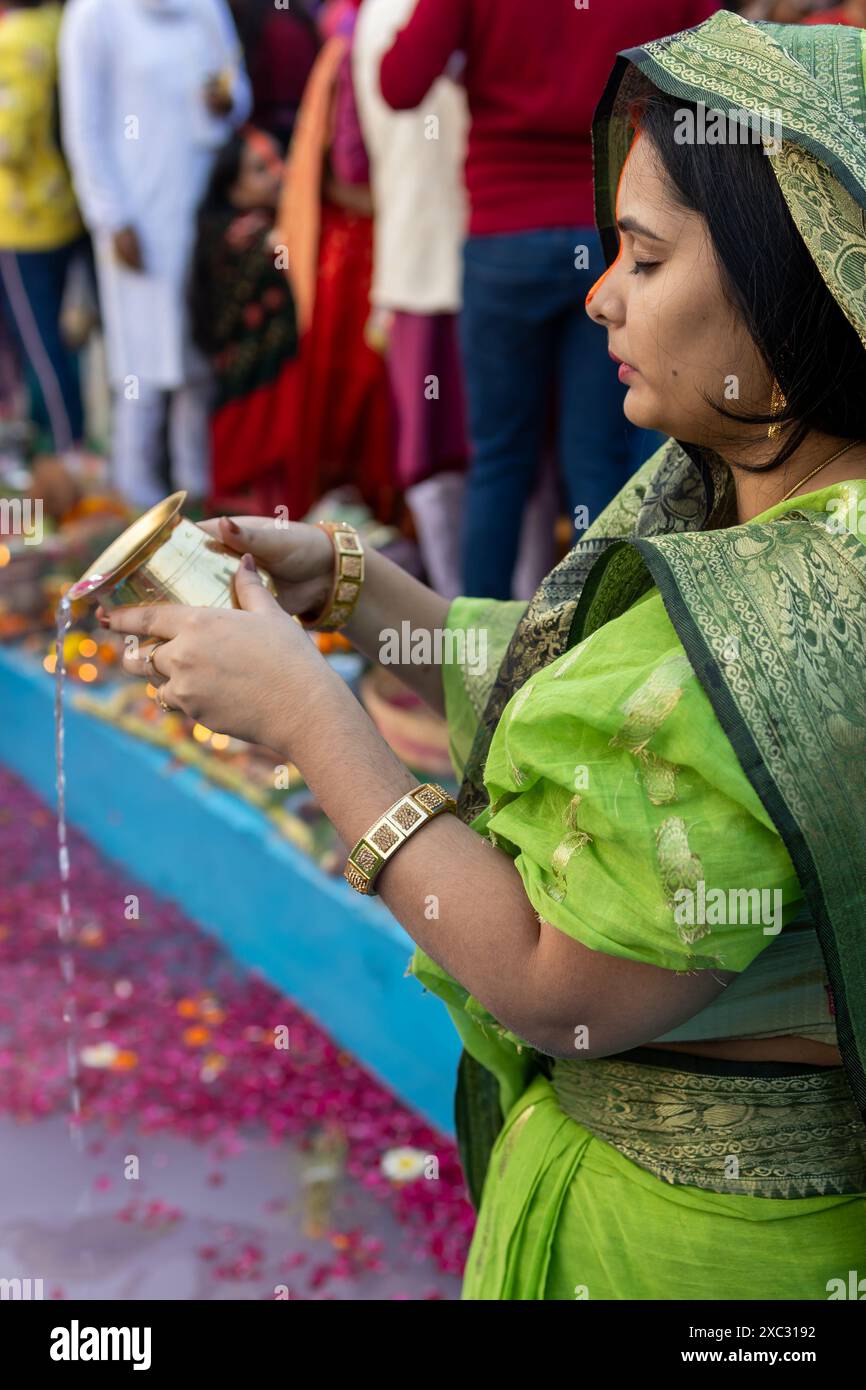 Indian woman pouring water puja hi-res stock photography and images - Alamy