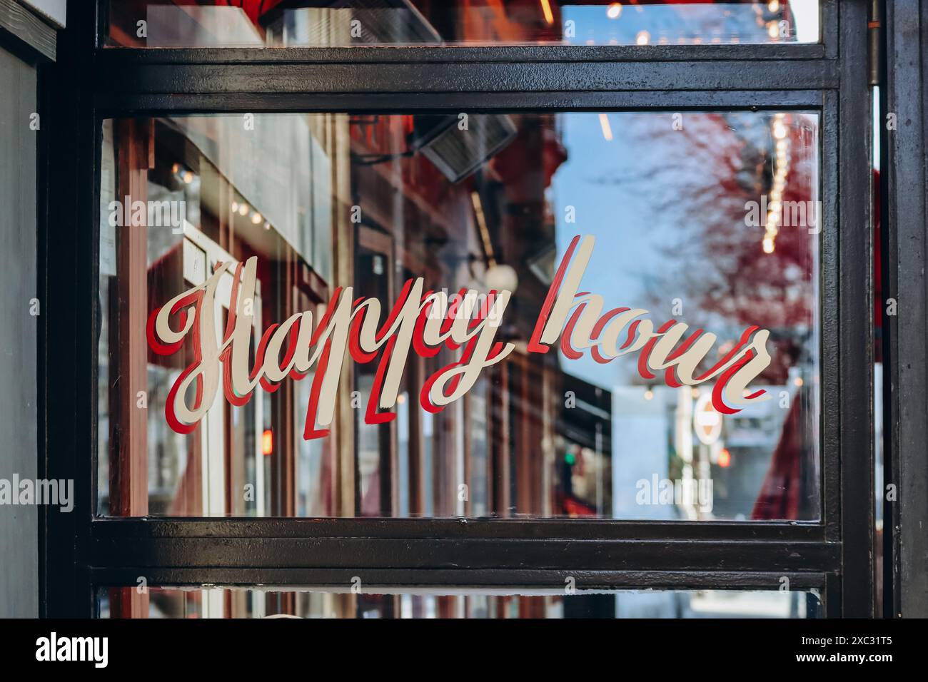 "Happy Hour" sign on a restaurant terrace window in Paris Stock Photo ...