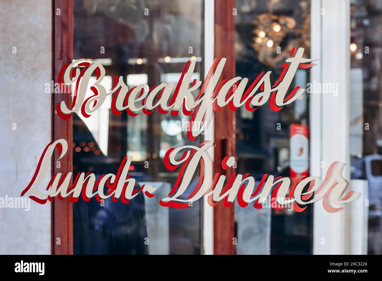 "Breakfast Lunch Dinner" sign on a restaurant terrace window in Paris ...