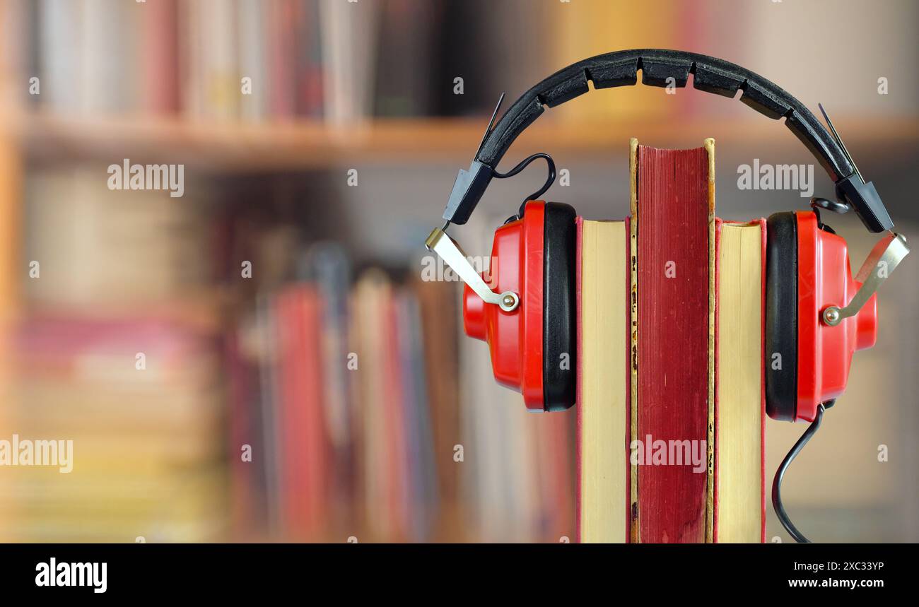audiobook concept with row of books and vintage headphone,blurred ...