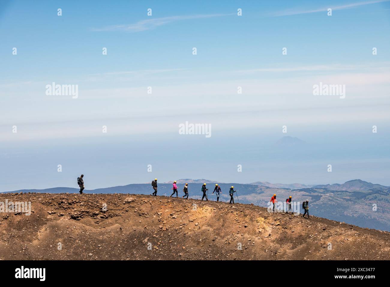 A guided tour group visiting the active summit craters of Mount Etna ...
