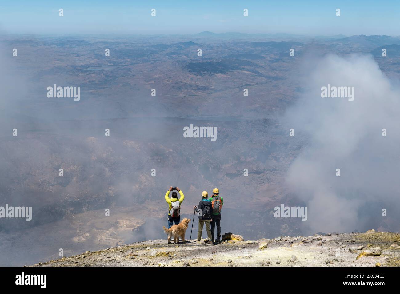 Hikers (with dog) on the edge of the Voragine crater (Central Crater ...